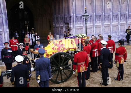 The Bearer Party carry the coffin in to the funeral for Captain ...