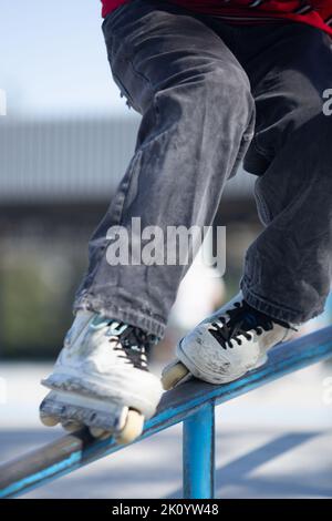 Roller grinding on a rail in skatepark during skate competition in ...