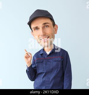 Funny car mechanic with big head on light beige background Stock Photo ...