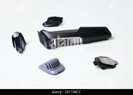 Defocus electric clipper with different set on white background ...