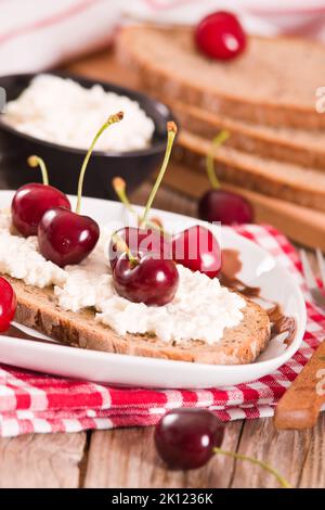 Rye bread with cottage cheese and cherries Stock Photo - Alamy