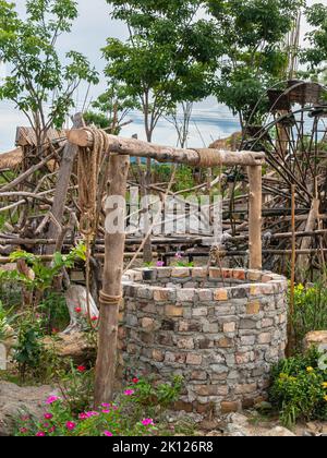 old well made of bricks and wooden pole Stock Photo - Alamy