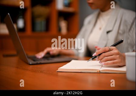 Cropped, A professional businesswoman looking the details on computer ...