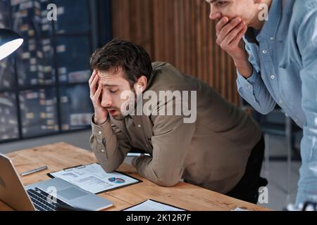 Two employees discussing the electronic document in a laptop Stock ...