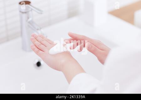 Japanese woman washing hands with foaming hand soap Stock Photo - Alamy