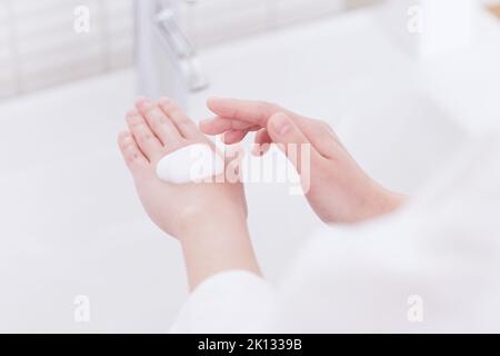 Japanese woman washing hands with foaming hand soap Stock Photo - Alamy
