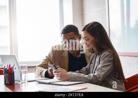 Busy coworkers cooperating and working together at office meeting, teamwork concept Stock Photo ...