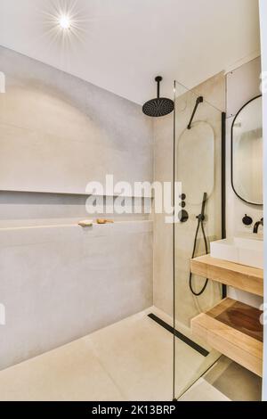 Sinks with mirrors and shower box with glass door in modern bathroom ...