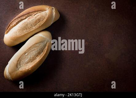 A top shot of bulk loaves of bread on the dark background Stock Photo ...