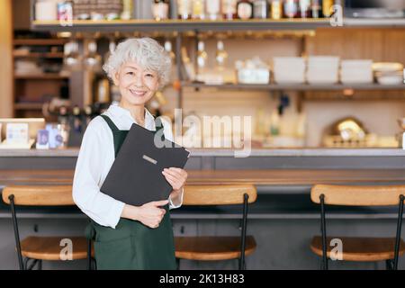 Japanese senior woman working at a restaurant Stock Photo - Alamy