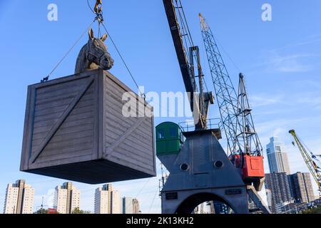 Crane holds a model of a crate containing a horse at the Port of ...