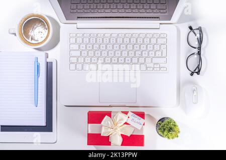 Present from secret santa on workplace table. Office Christmas and New ...