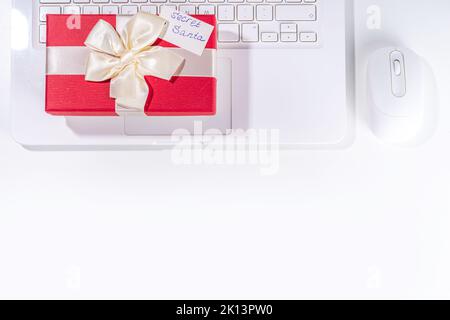 Present from secret santa on workplace table. Office Christmas and New ...