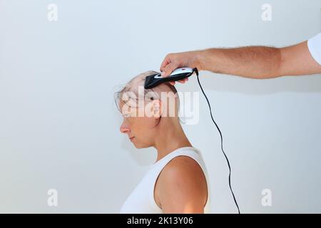 consequences of chemotherapy. Shaving off the last hair on the head ...