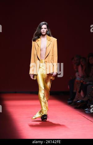 Model walks the runway at the Redondo Brand fashion show during ...