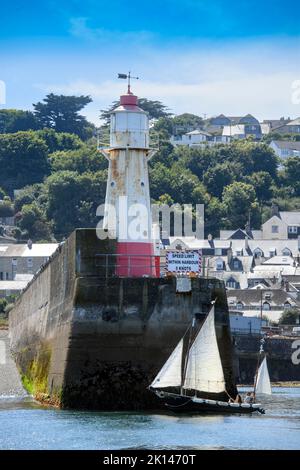 A sailing boat leaves Newlyn harbour in Cornwall, UK - the mean sea ...