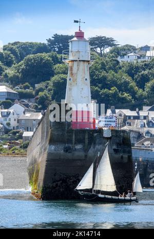 A sailing boat leaves Newlyn harbour in Cornwall, UK - the mean sea ...