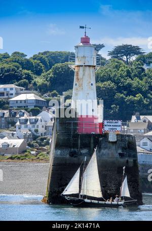 A sailing boat leaves Newlyn harbour in Cornwall, UK - the mean sea ...
