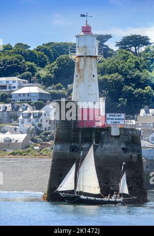 A sailing boat leaves Newlyn harbour in Cornwall, UK - the mean sea ...