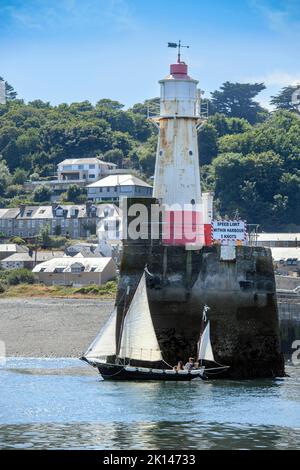 A sailing boat leaves Newlyn harbour in Cornwall, UK - the mean sea ...