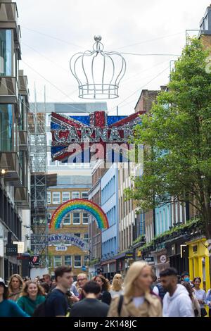 People walk under a rainbow flag during Pride Parade, in Sofia ...