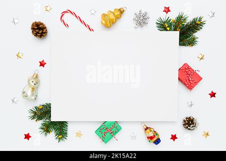 Composition with Christmas gifts, candy canes and balls on light ...