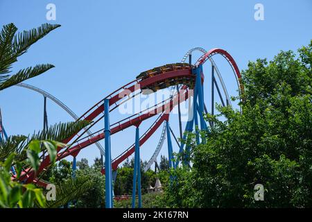 Inverted roller coaster with narrow metal rails, an ideal summer day to ...