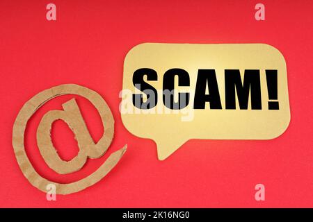 Email and business. On a red surface, a symbol and a sign with the ...