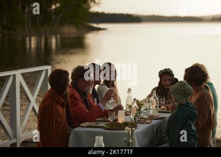 Family having midsummer meal at lake Stock Photo - Alamy