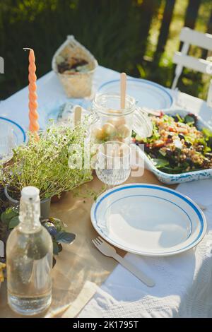 Overhead view of summer place setting with pink peonies Stock Photo - Alamy