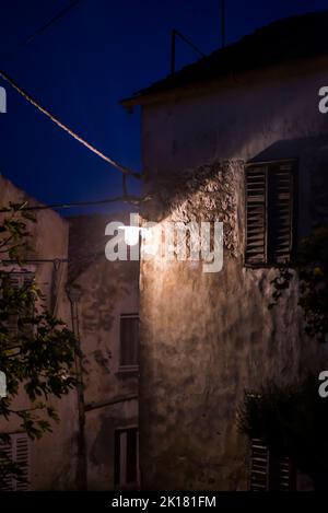 Empty, narrow street at night, Veli Iz, Island of Iz, Zadar archipelago ...