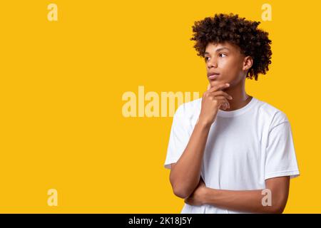 Pensive black teenager. Think idea. Young african guy in doubtful pose ...