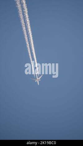 Single small airplane flying diagonal on the minimalist background of ...