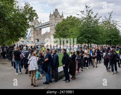 Members of the public queue back to tower bridge to pay their respects ...