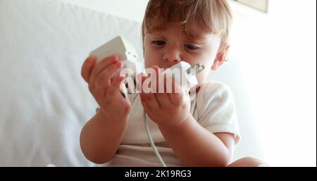 Baby unplugging smartphone charger cable, toddler boy unplugs cellphone ...