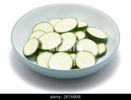 Sliced zucchini circles in ceramic bowl isolated on white background ...