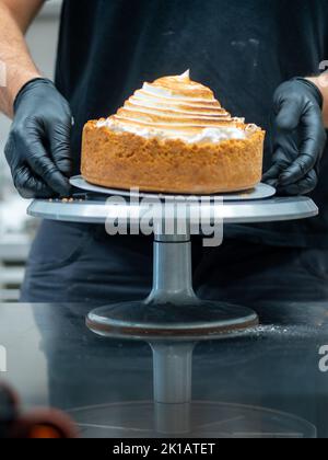 baker using a pastry burner flame torch on a meringue cake Stock Photo ...