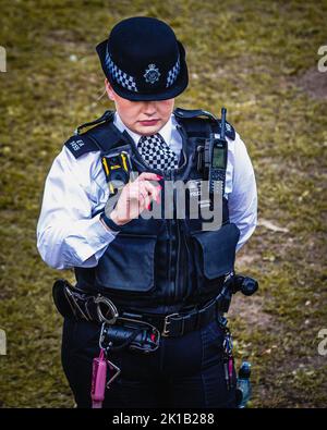A police officer wipes away tears amid mourners during the join funeral ...