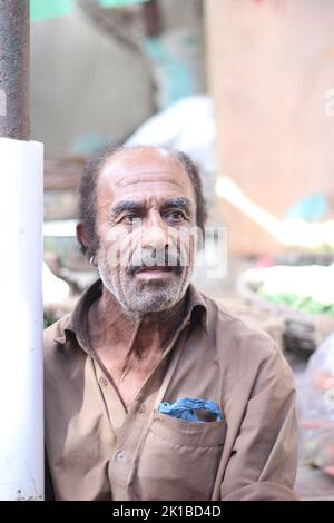 A vertical shallow focus of a Pakistani old male with a mustache in a ...