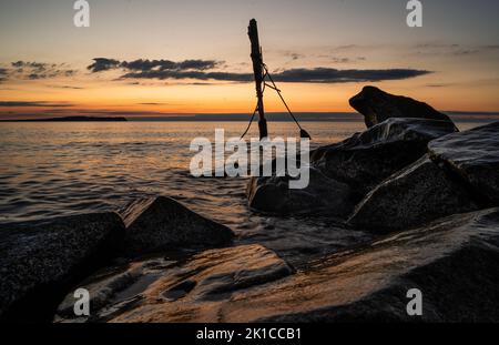Rocky beach coastline on Ruegen island in Germany during sunset over ...