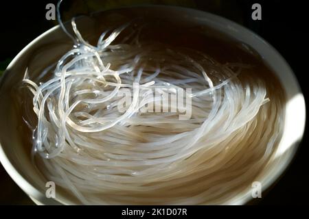 Glass noodles soaked in water. The photo was taken under natural light ...