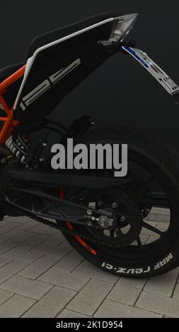 A closeup shot of a modern bike parked near the wall Stock Photo - Alamy