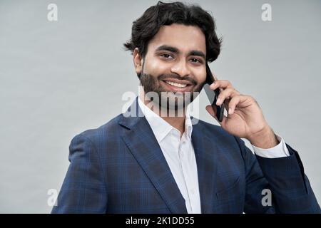 Young arab man talking on the smartphone eating ice cream at street ...