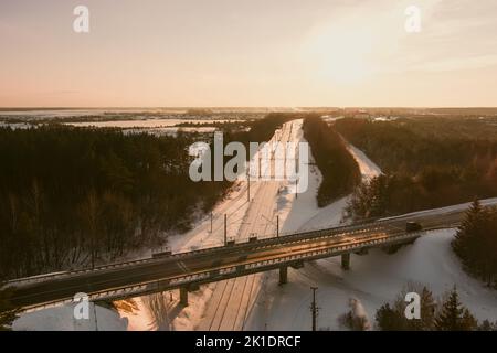 Aerial view of a railroad among pine forests at winter. Winter scenery ...
