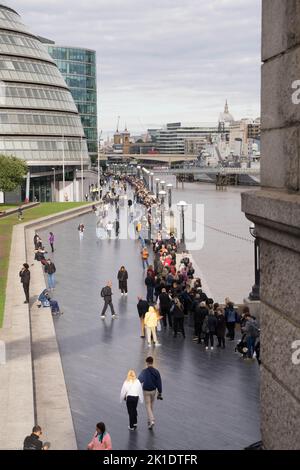 people joining the queues along the banks of the River Thames to pay ...