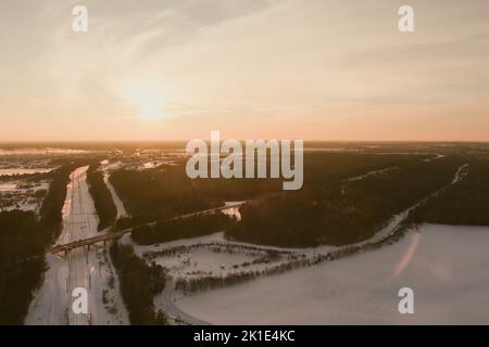 Aerial view of a railroad among pine forests at winter. Winter scenery ...