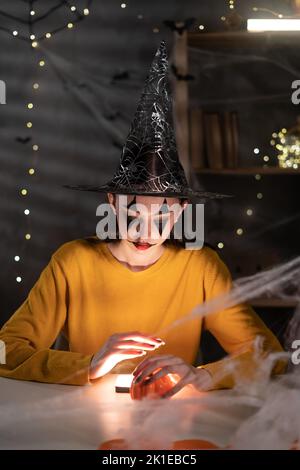 Halloween Young witch woman conjures in the woods Stock Photo - Alamy