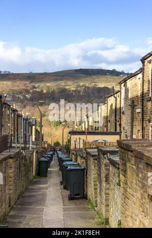 Bins in the back alley between terraced properties at the model village ...