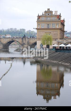 A scenic shot of a bridge over the Vltava river with ships in Czech ...