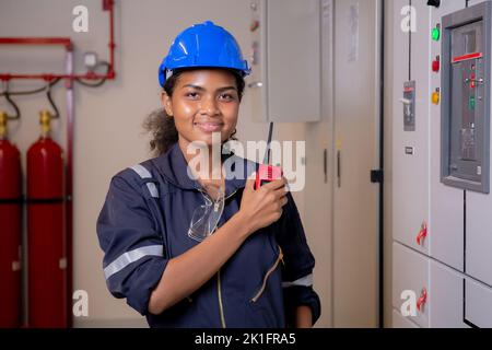 Electrical young asian woman engineer examining maintenance cabinet ...